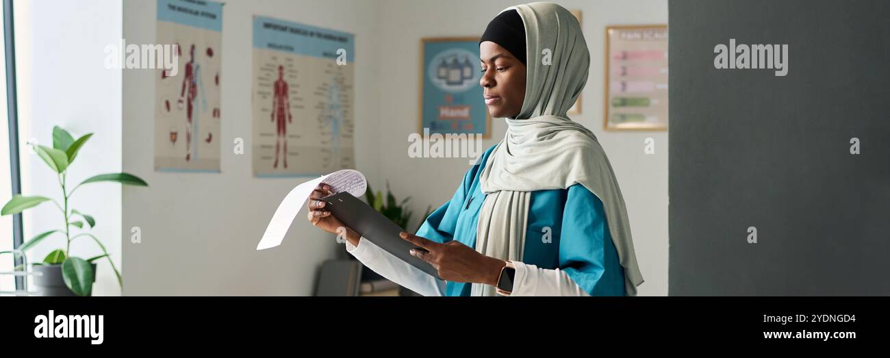 Muslim woman wearing traditional hijab studying medical notes in a ...