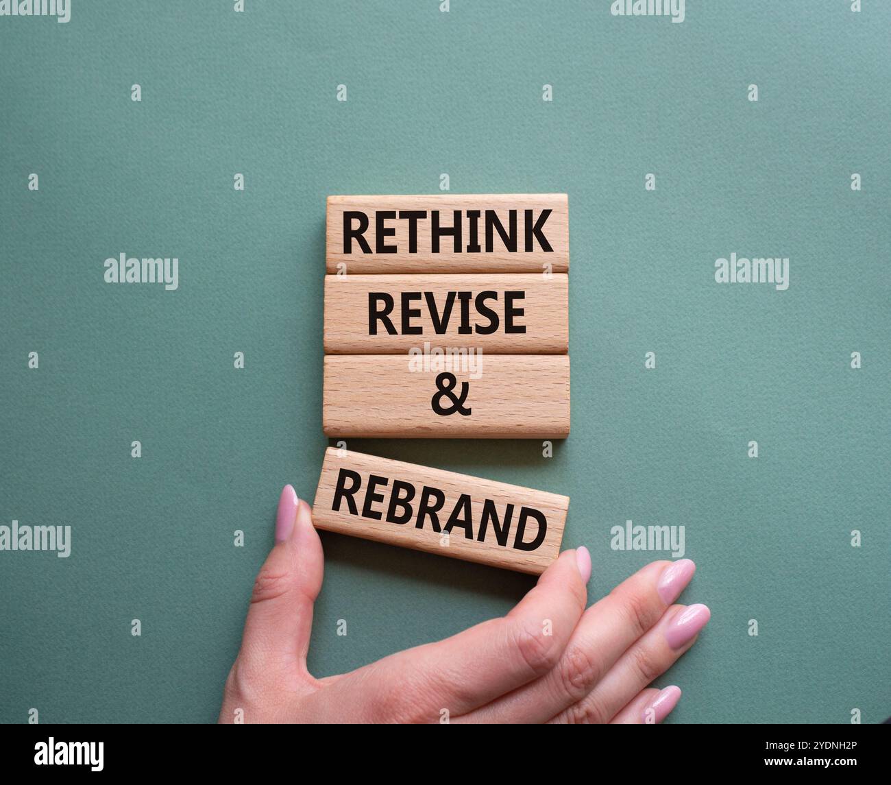 Rethink Revise and Rebrand symbol. Wooden blocks with words Rethink Revise and Rebrand ...