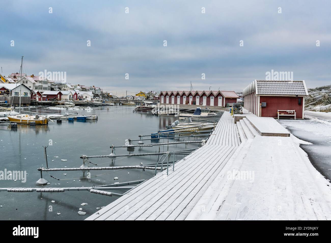 The harbor reveals a tranquil winter landscape where snow blankets the ...