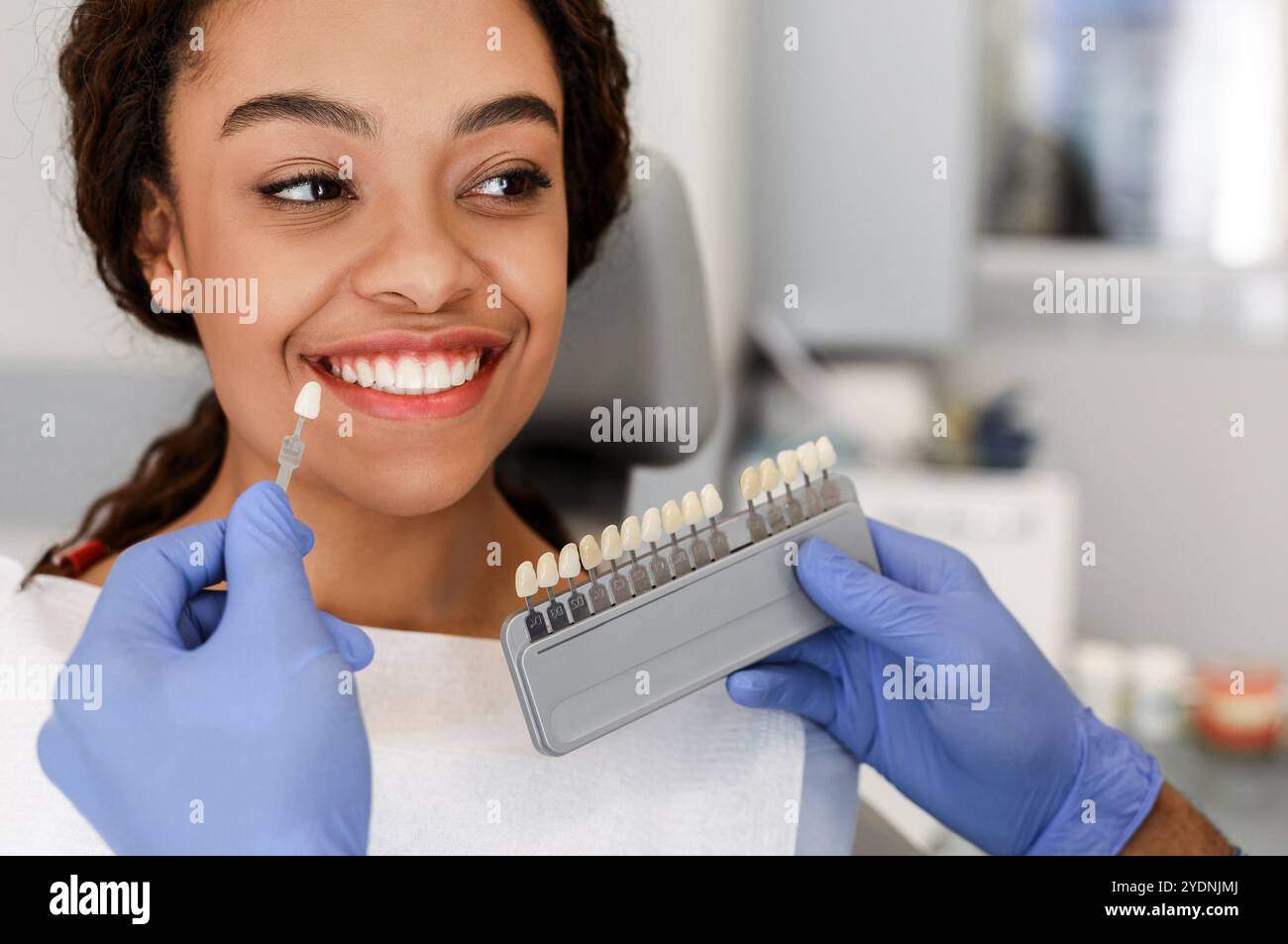 Dentist applying sample from tooth scale to patient teeth Stock Photo ...