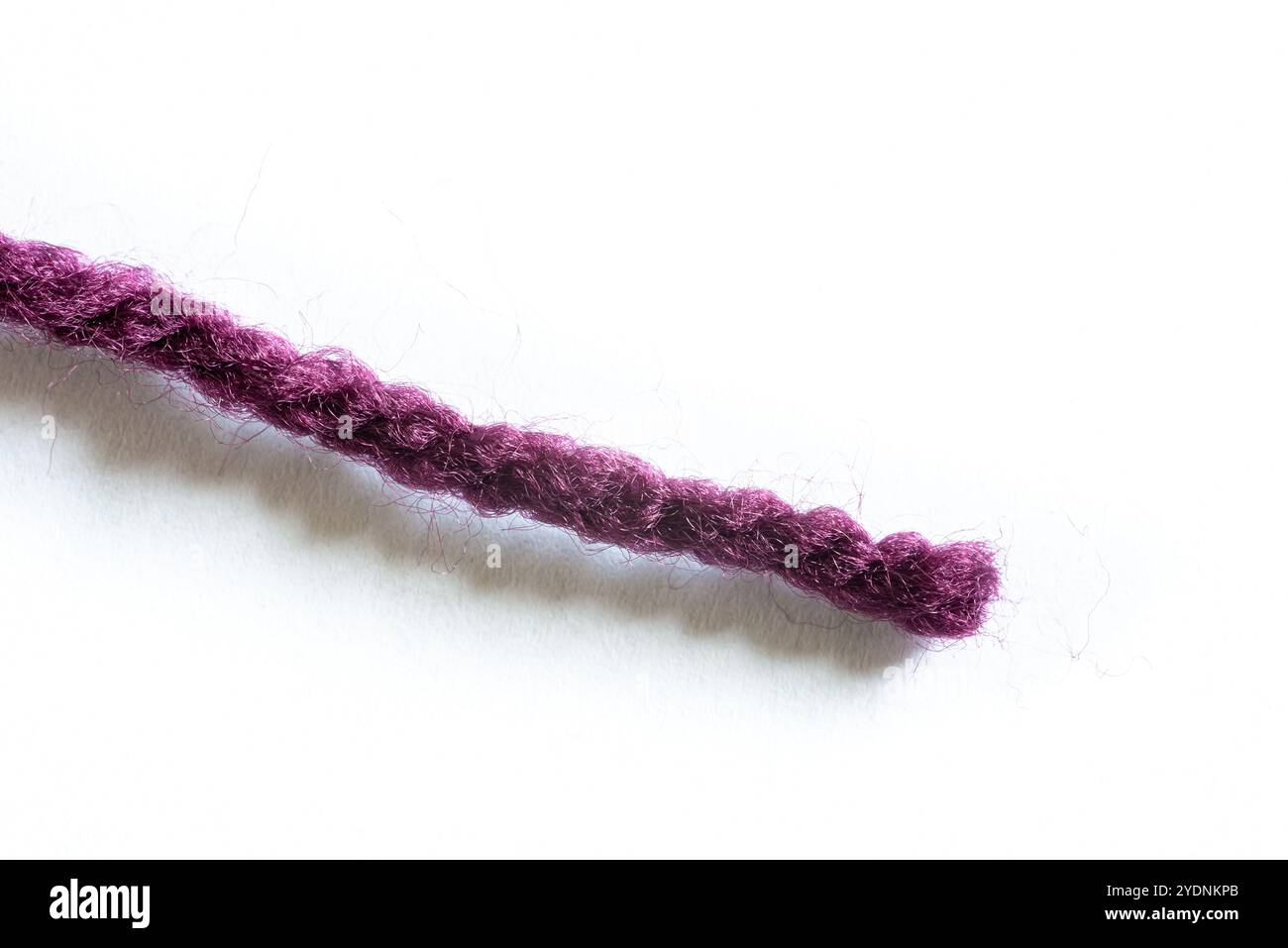 Macro shot of a piece of purple colored wool. Incredibly tiny threads ...
