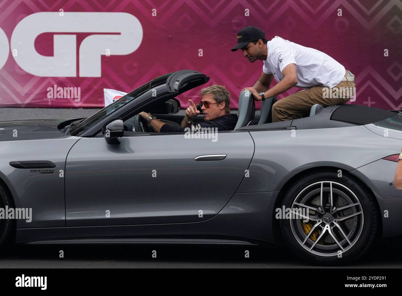 Actor Brad Pitt drives a car during the drivers parade before the ...