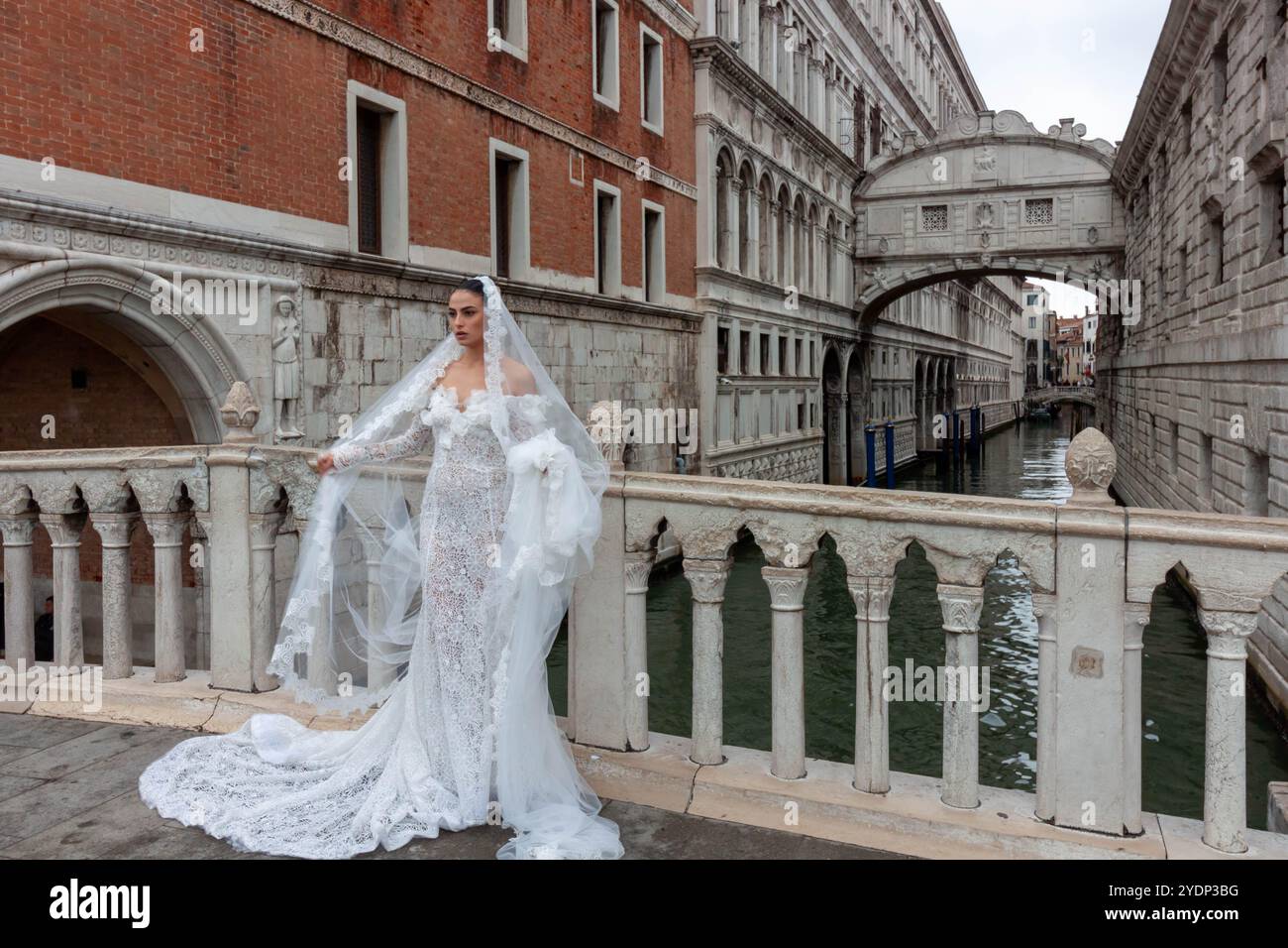 VENICE, ITALY - OCTOBER 24, 2024: An unknown model poses in front of ...