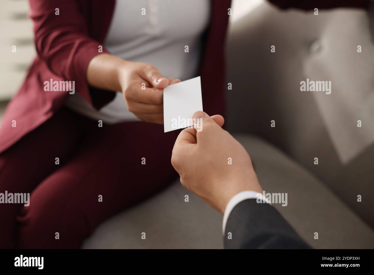 Woman giving business card to man in office, closeup. Mockup for design ...