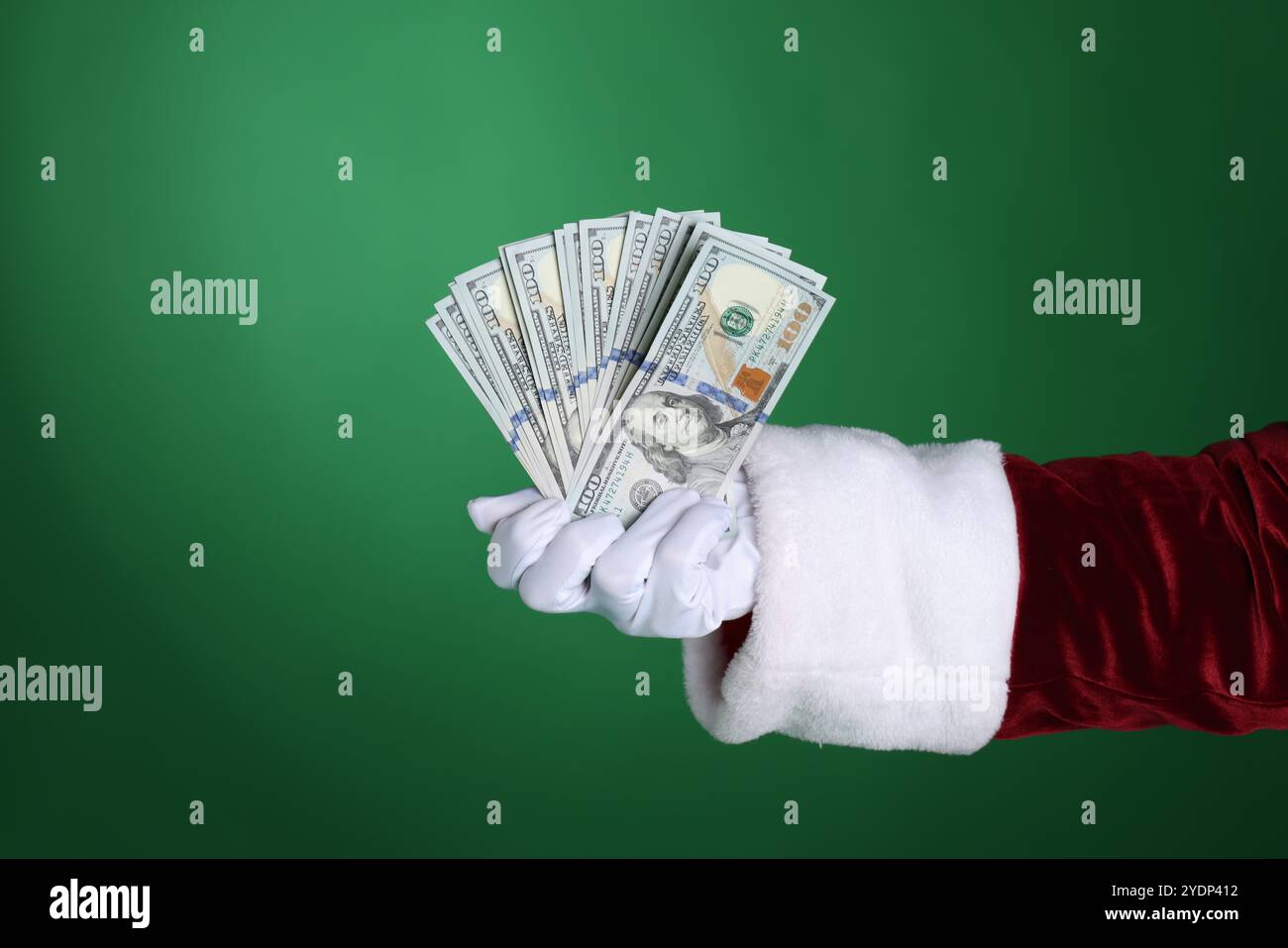 Santa Claus holding dollar banknotes on green background, closeup ...