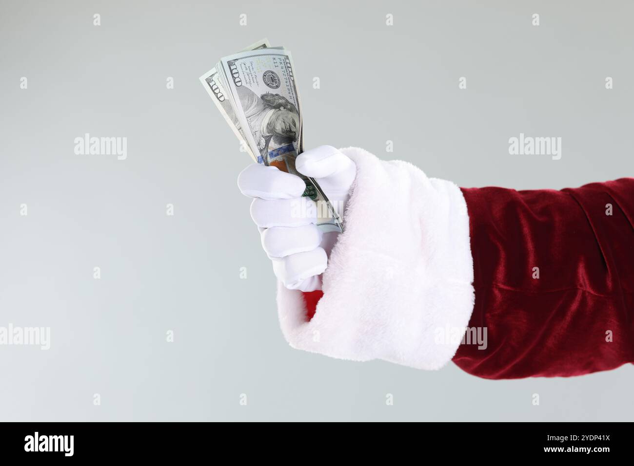 Santa Claus holding dollar banknotes on gray background, closeup Stock ...
