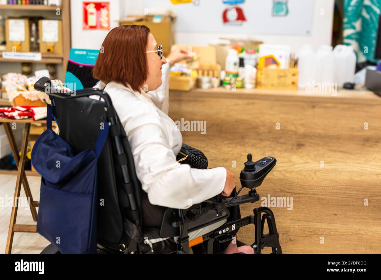 Customer in Wheelchair Exploring Product Range at Accessible Store ...