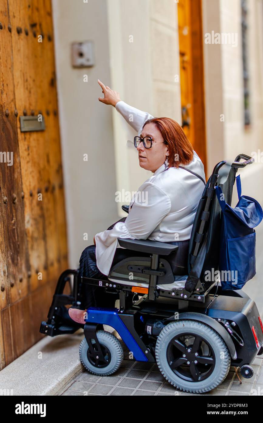 Wheelchair User Reaching for Inaccessible Doorbell Stock Photo - Alamy