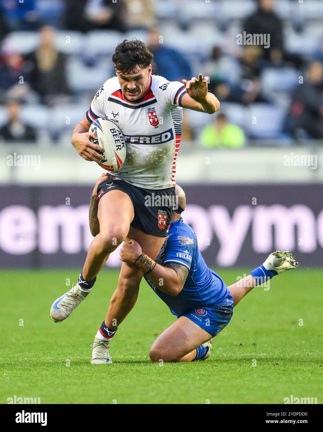 Herbie Farnworth of England is tackled by Jazz Tevaga of Samoa during ...