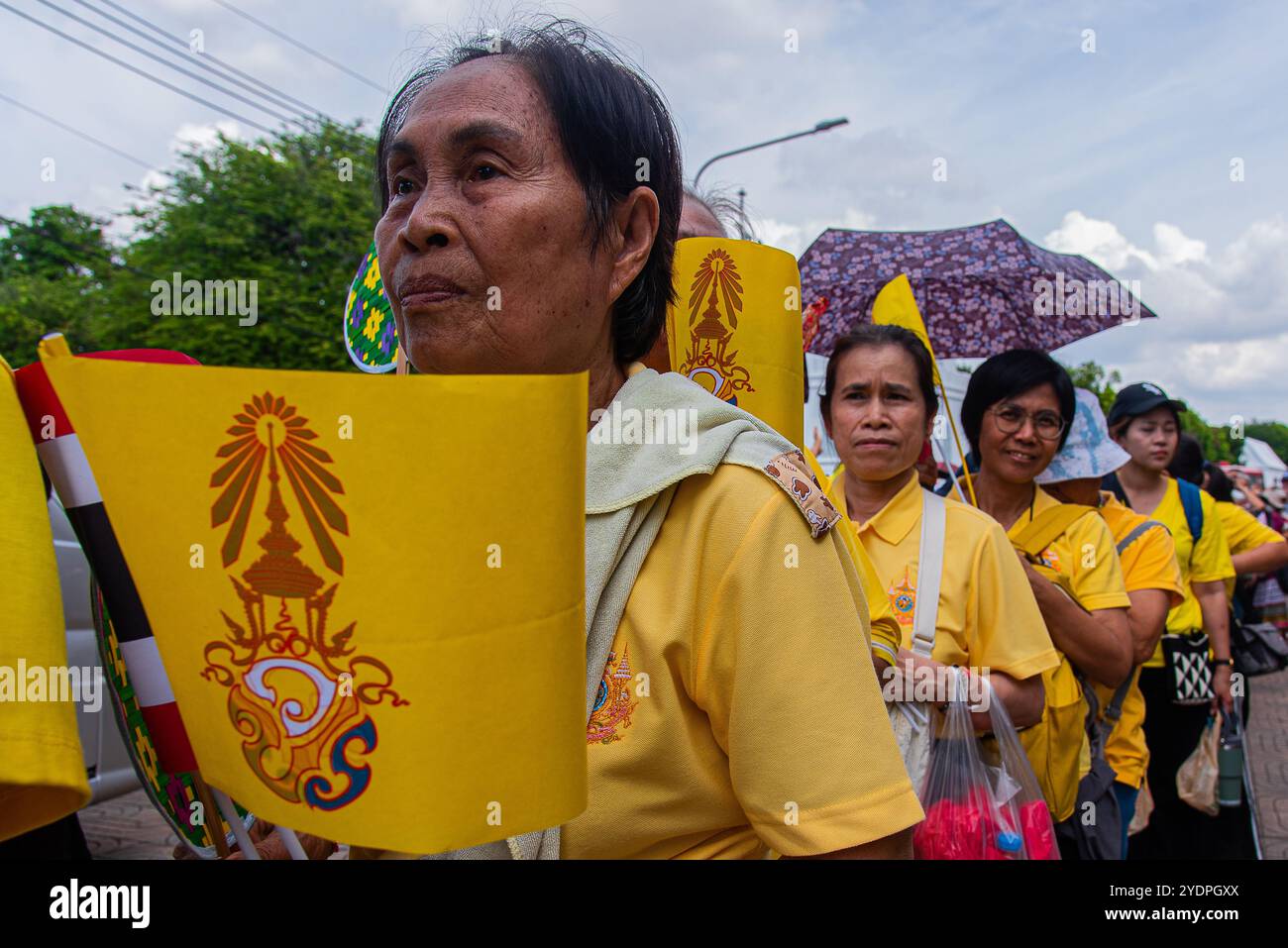 Spectators queue to watch the royal barge down the Chao Phraya River ...