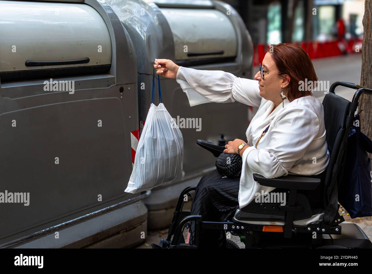 Accessible Waste Disposal by Wheelchair User in City Stock Photo - Alamy