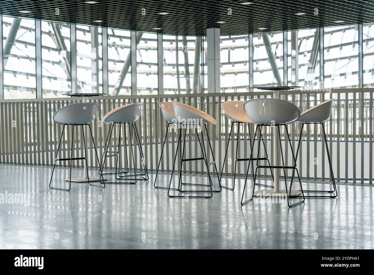 Modern chairs in an ultra-modern hall with glass walls Stock Photo - Alamy