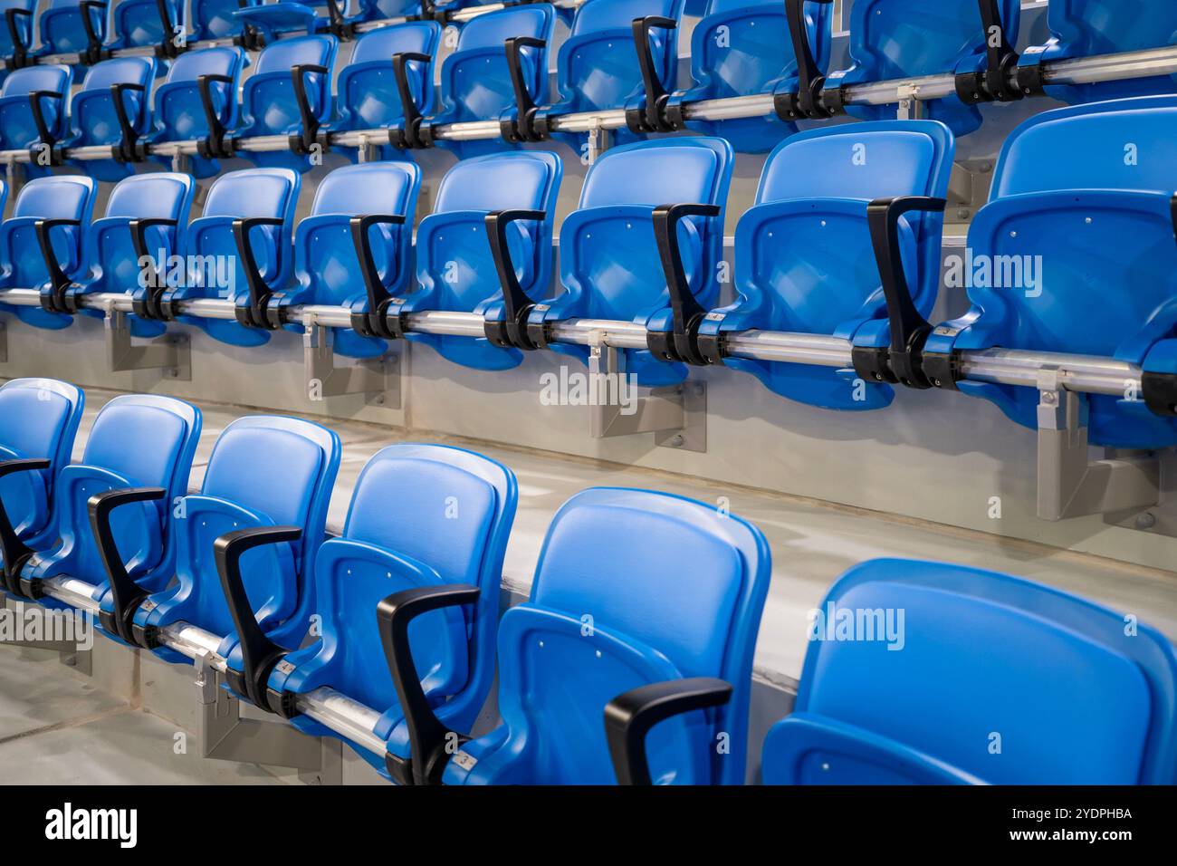 A long row of modern blue chairs with folding seats in a hall Stock ...
