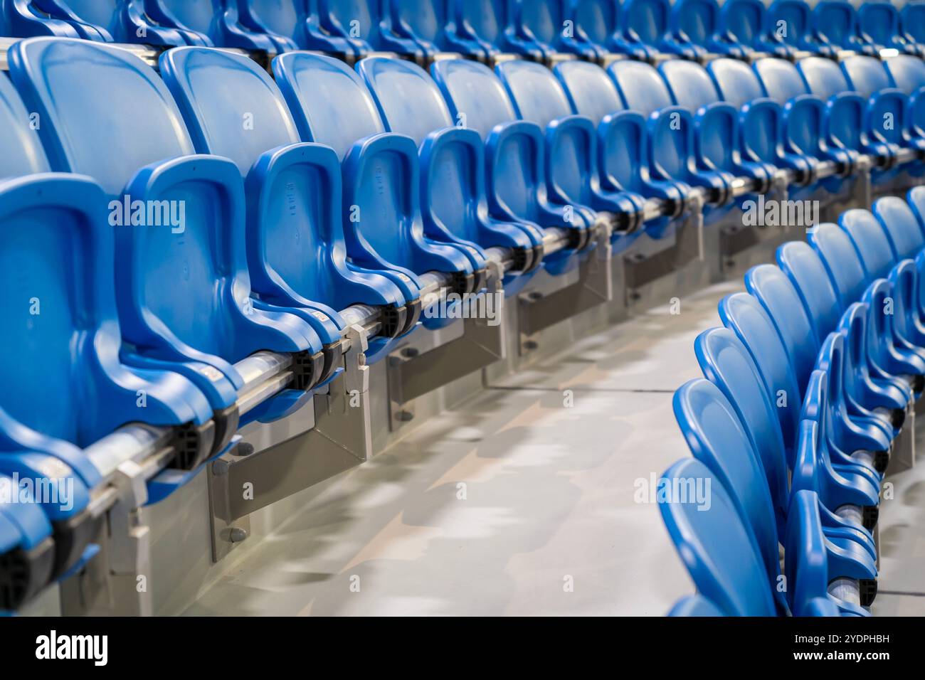 A long row of modern blue chairs with folding seats in a hall Stock ...