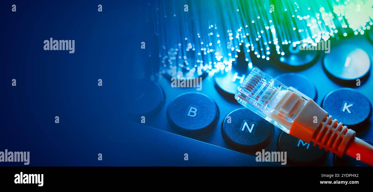 Ethernet cable on computer keyboard. Fast internet concept with optical ...