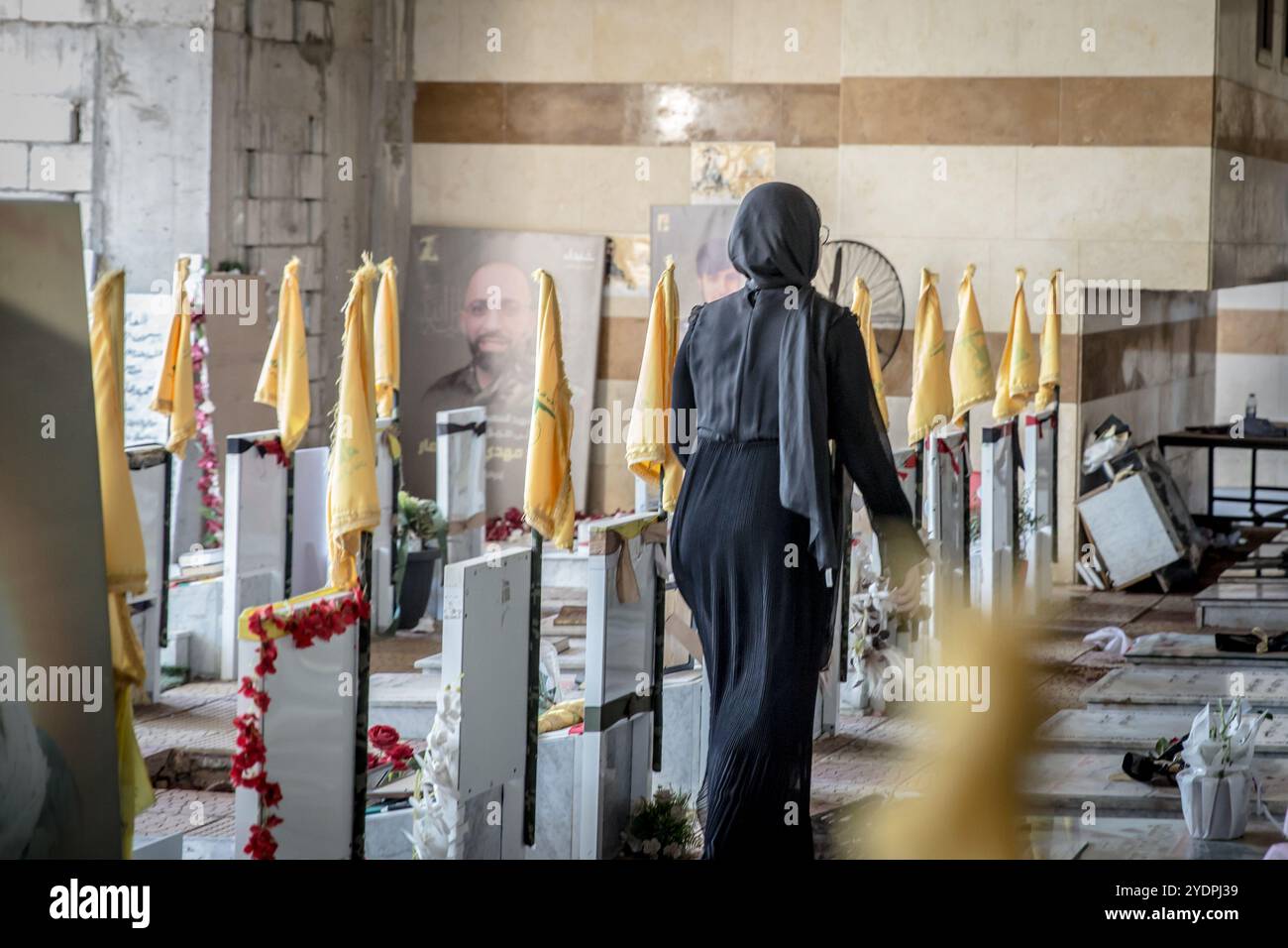 A woman walks past graves at the Rawdat Alhawra' Zaynab cemetery for ...