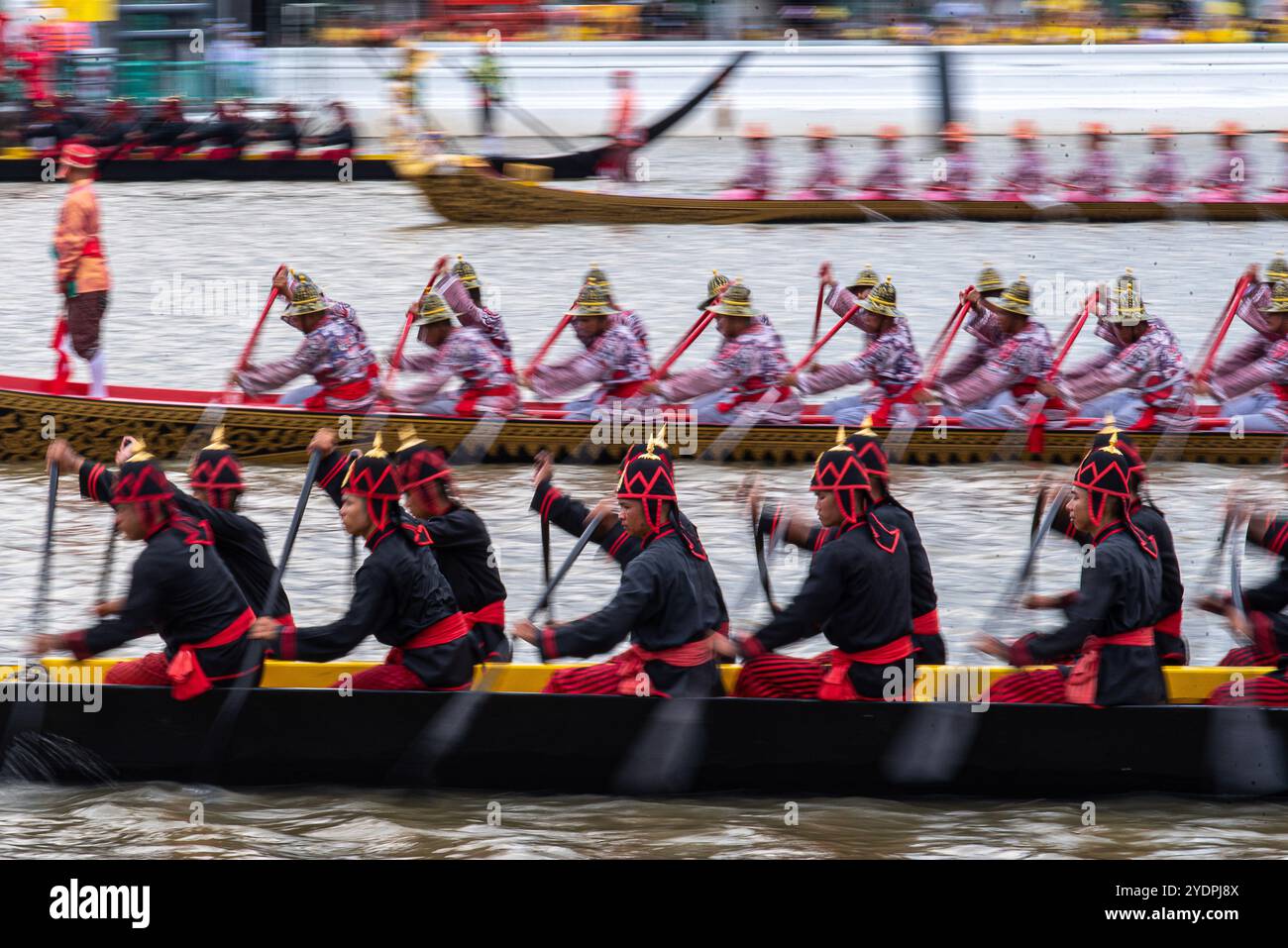 Bangkok, Thailand. 27th Oct, 2024. Rowers paddle ornate barges down the ...