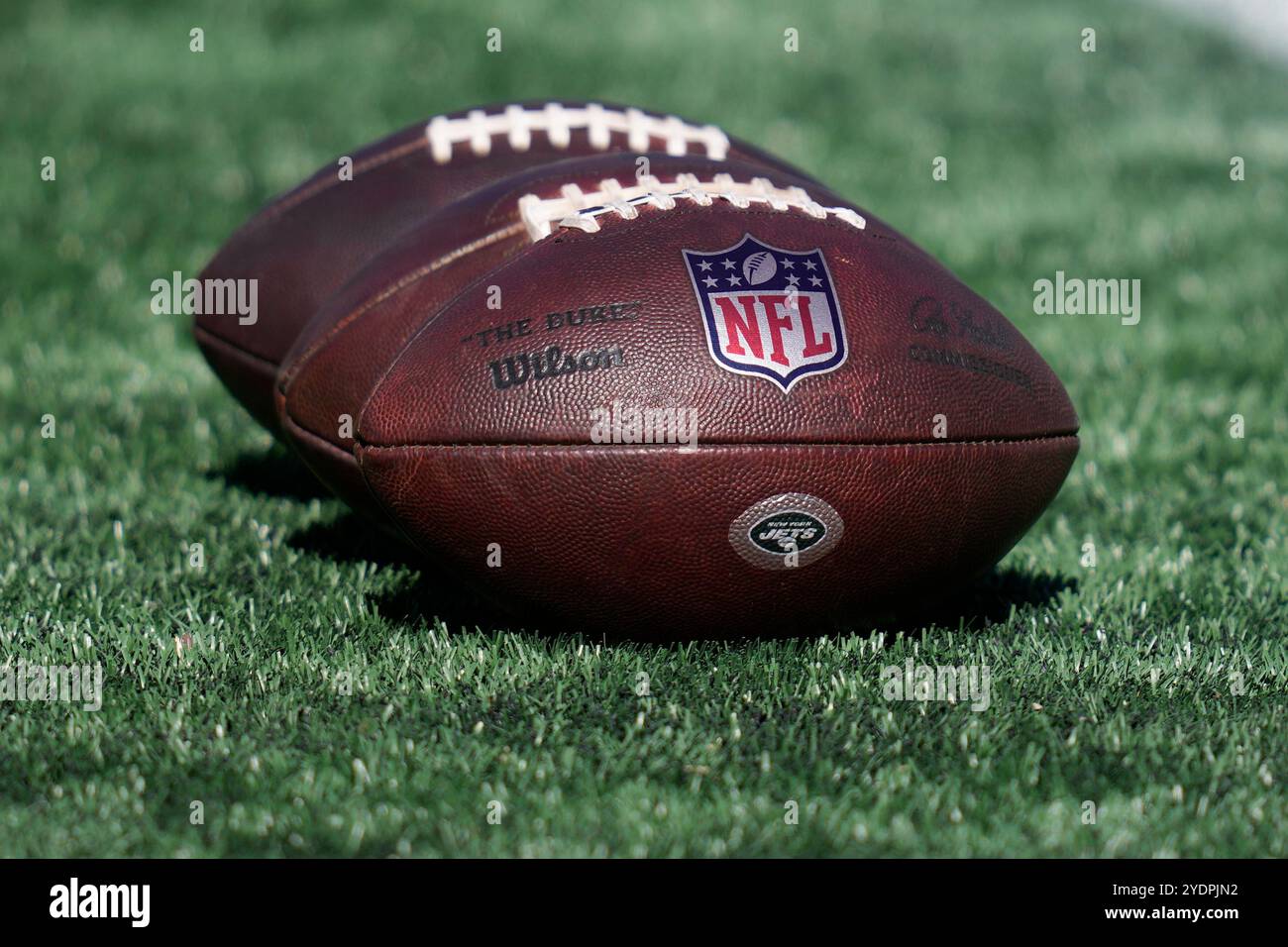 Footballs rest on the field prior to an NFL football game, Sunday, Oct ...