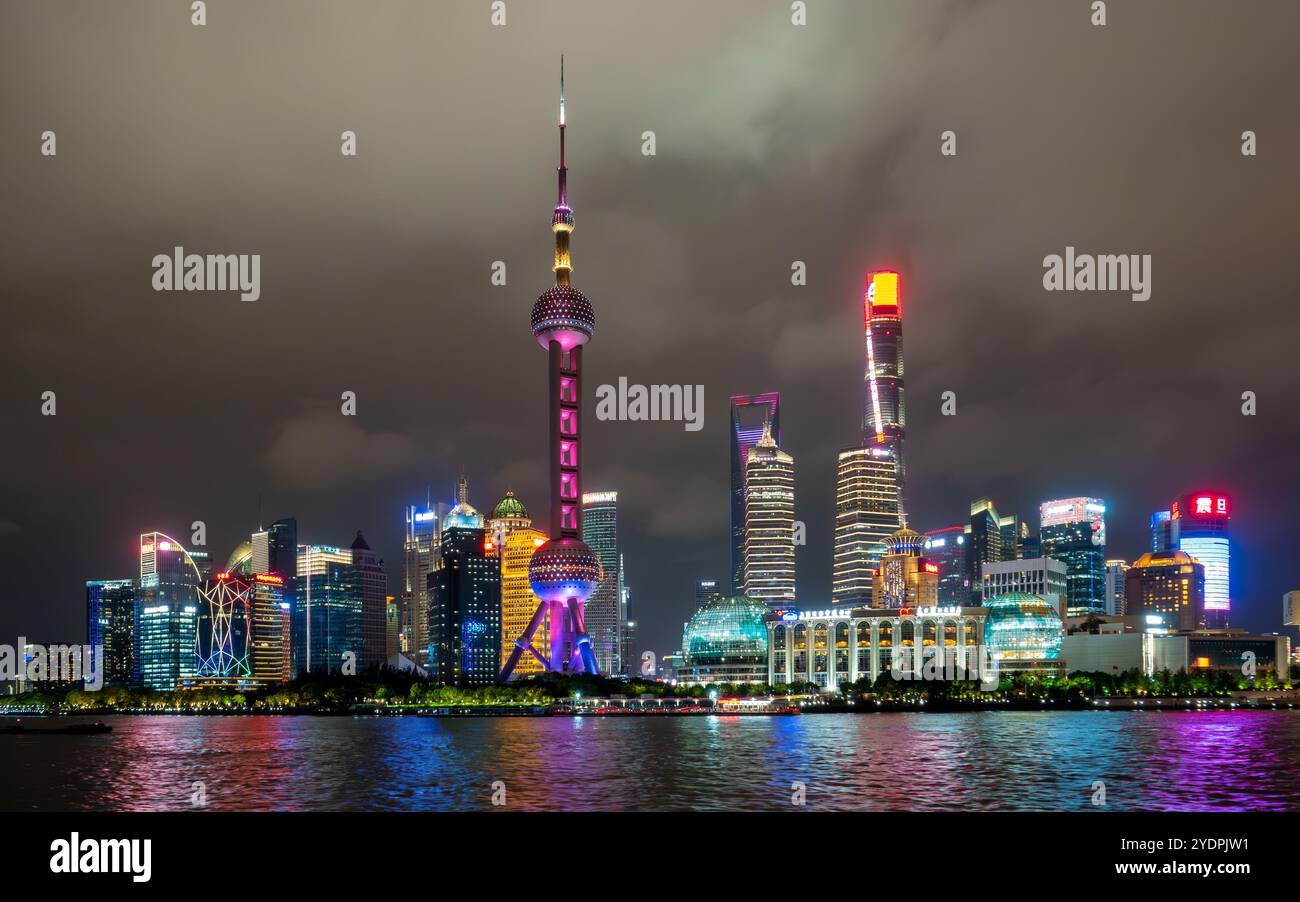 Shanghai night time city skyline over the Yangtze Stock Photo - Alamy