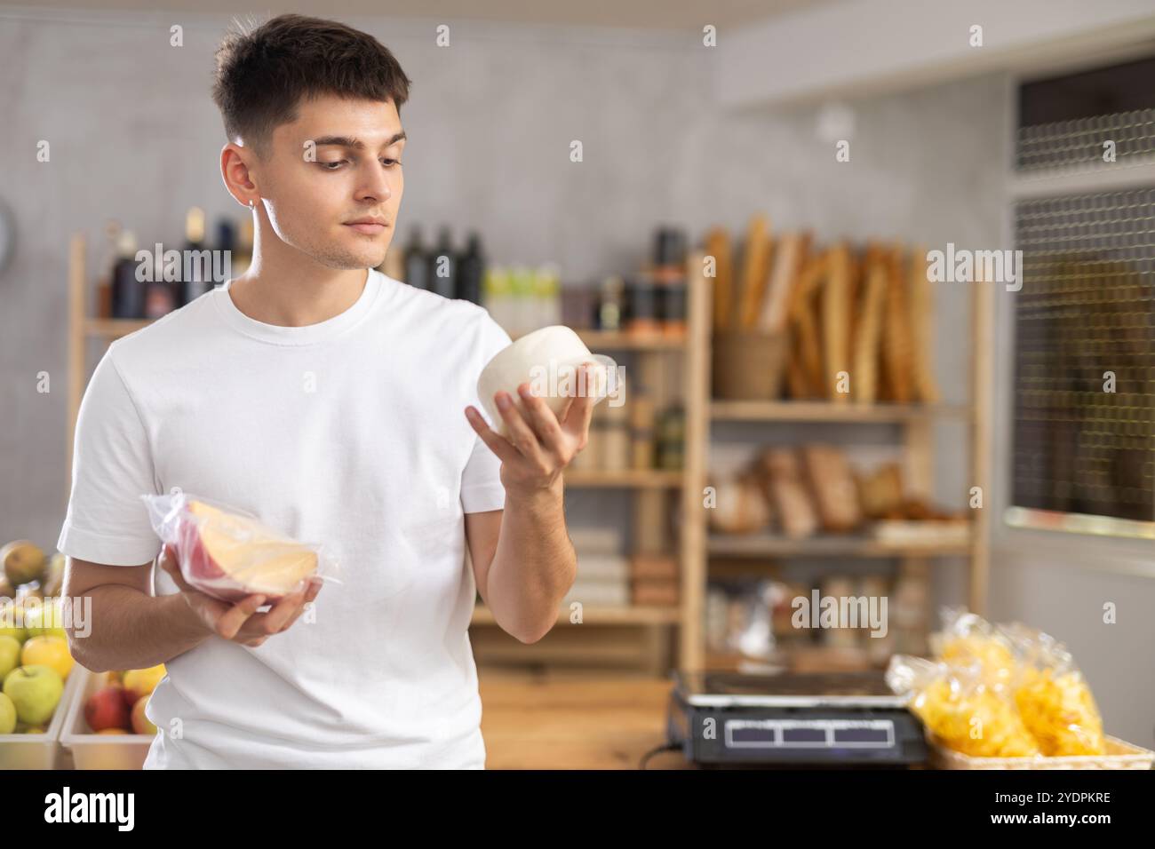 Male shopper chooses which cheese to buy at supermarket Stock Photo - Alamy