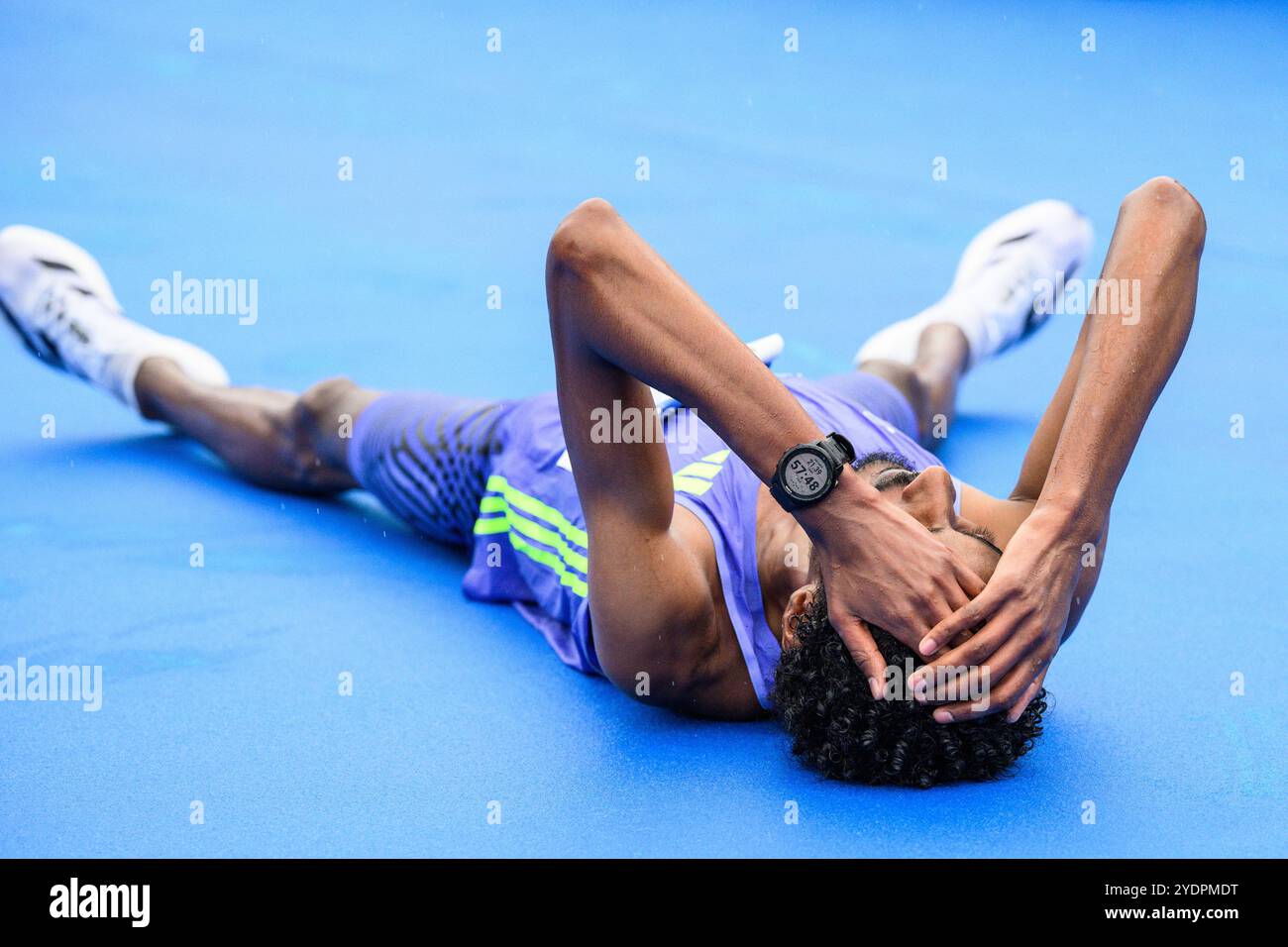 Ethiopian runner Yomif Kejelcha lying on the ground after winning the ...