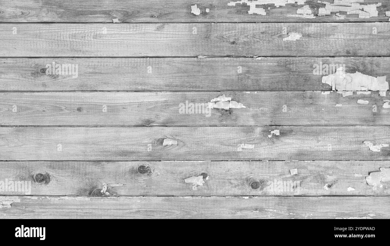 A wooden board background with a lot of holes and splinters. The board ...