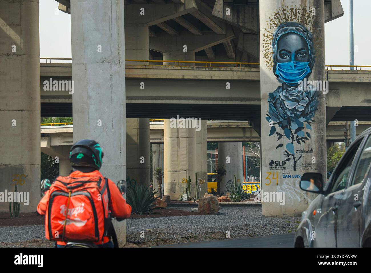 Mural of a nurse or doctor with a face mask painted on a concrete ...