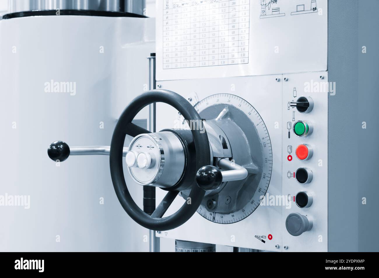 A machine with a black and silver handle with a white and black knob ...