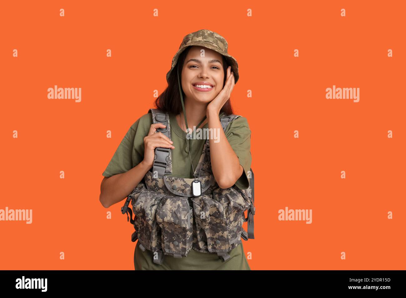 Beautiful young female soldier laughing on orange background Stock ...