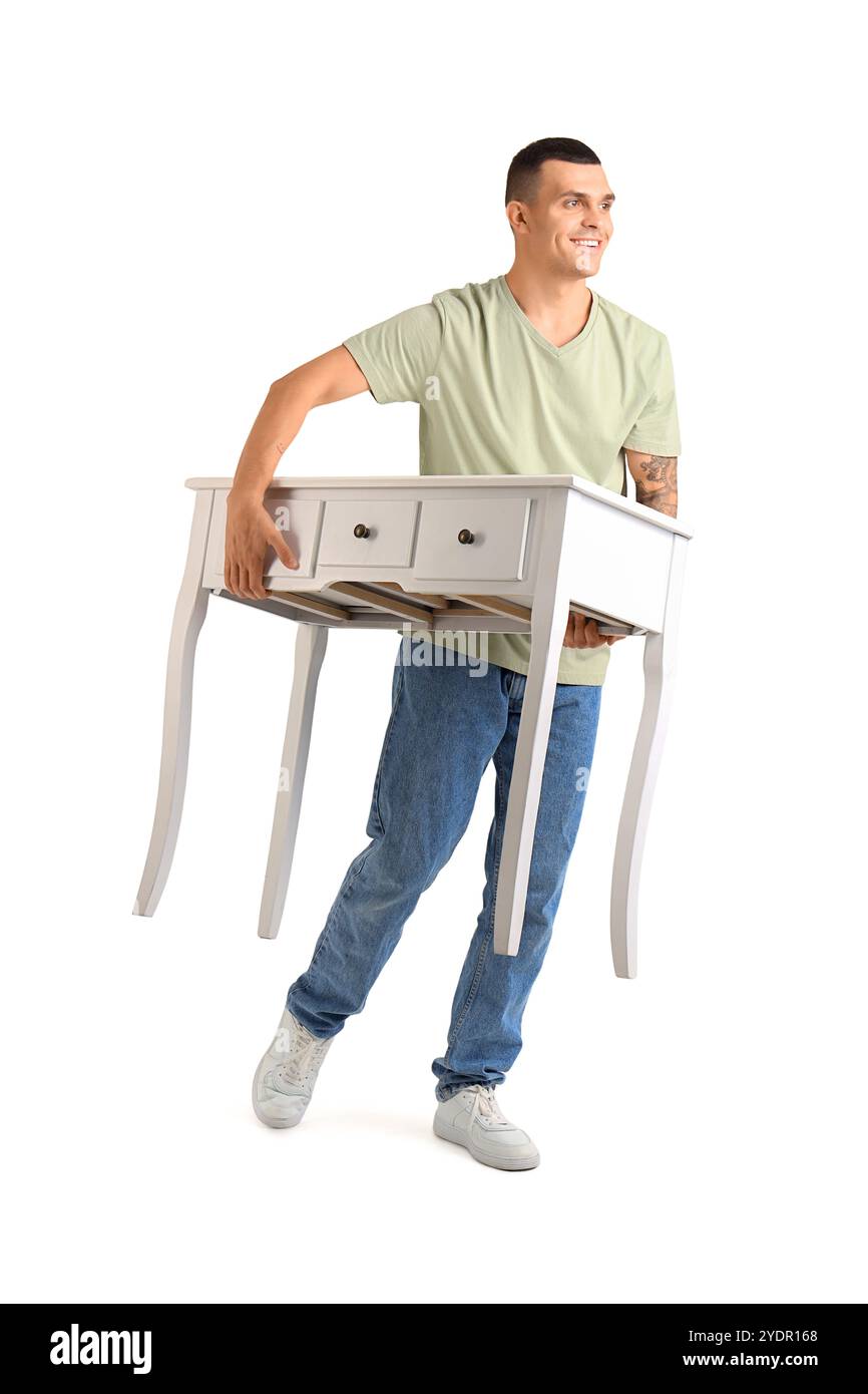 Young man carrying table on white background Stock Photo - Alamy