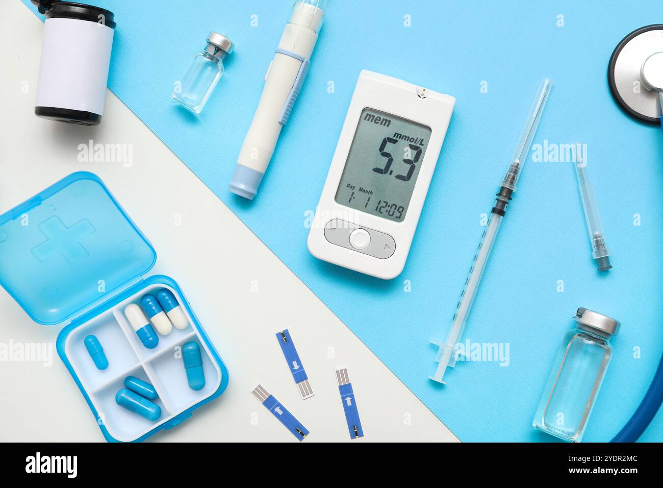 Glucometer with lancet pen, insulin and pills on color background ...