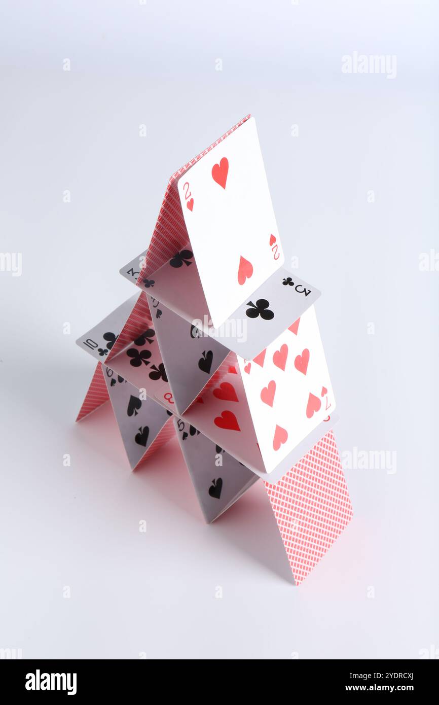 House of playing cards on white background Stock Photo - Alamy