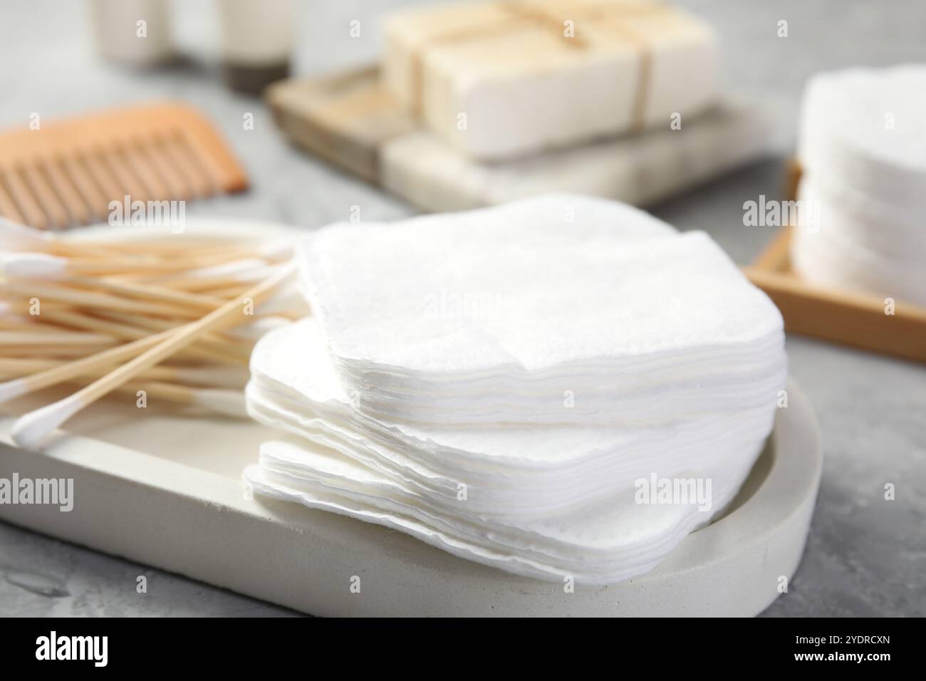 Clean cotton pads and swabs on grey table, closeup Stock Photo - Alamy