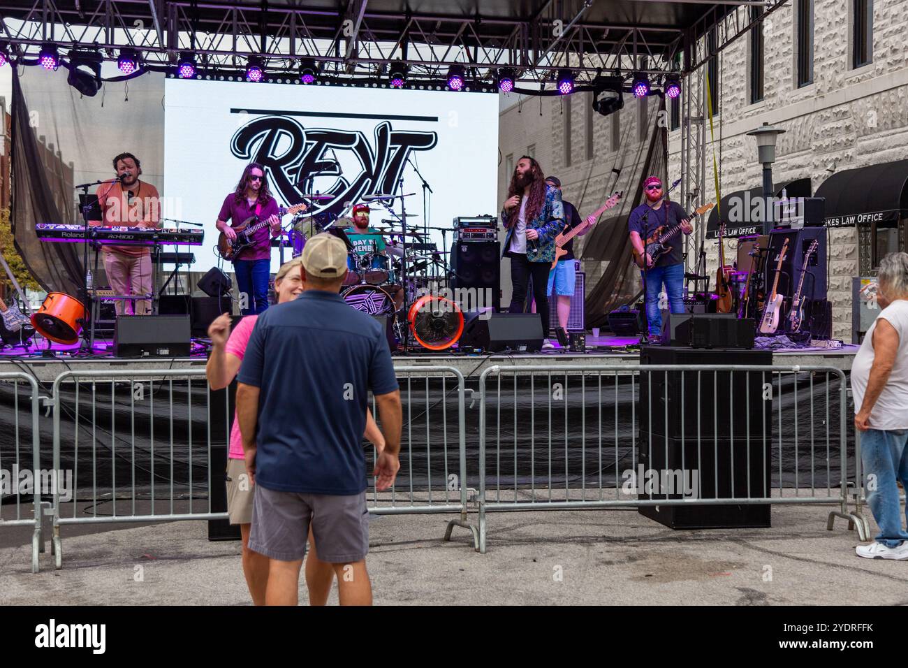 A couple dances to music by the band "Rekt," performing onstage in ...