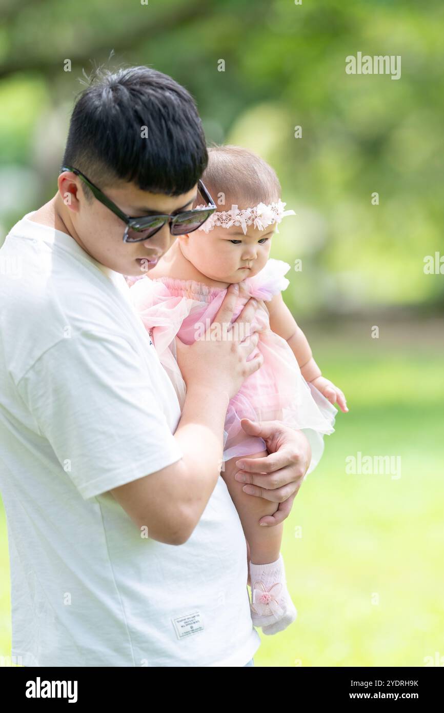 A Taiwanese couple in their 20s and their 7-month-old baby celebrate a ...