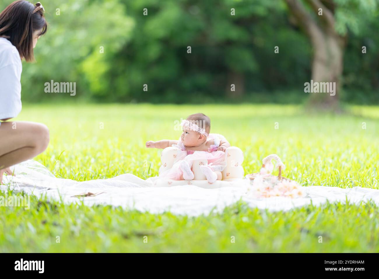 A Taiwanese couple in their 20s and their 7-month-old baby celebrate a ...
