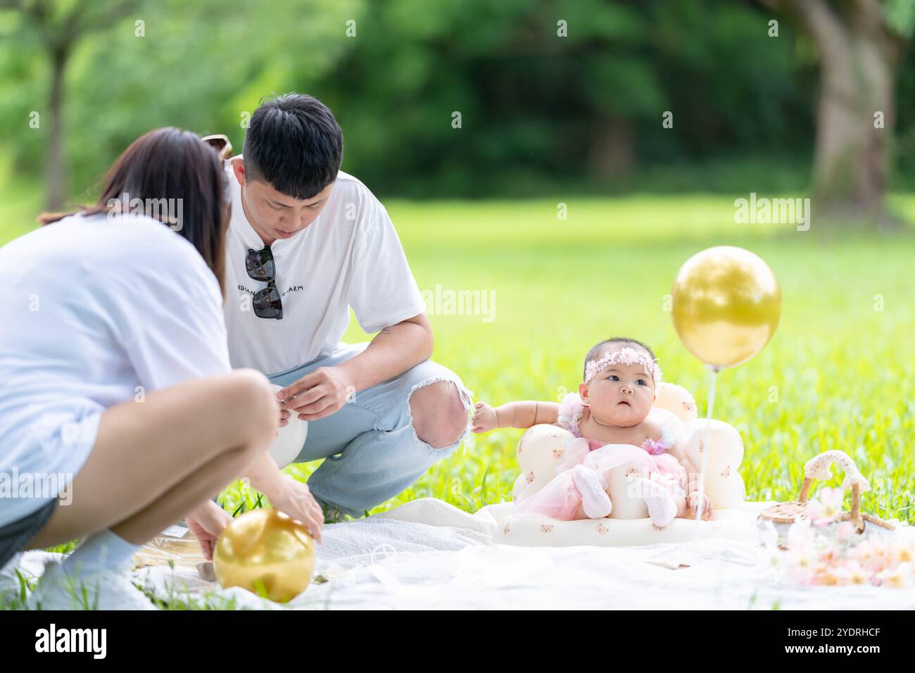 A Taiwanese couple in their 20s and their 7-month-old baby celebrate a ...