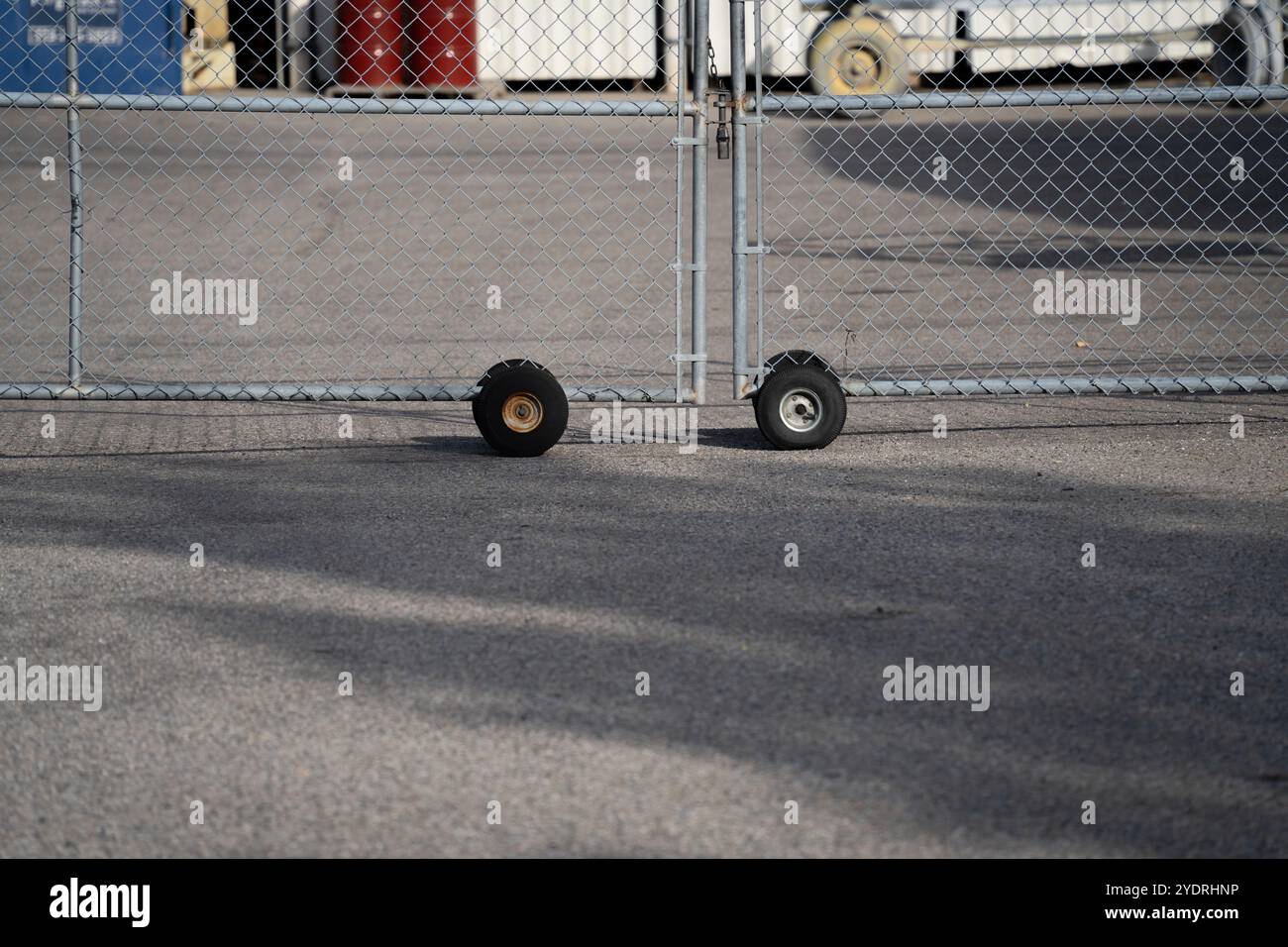 Chain link fence with with tires on the gate Stock Photo - Alamy