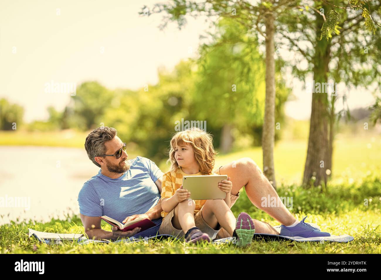 Father shapes son education. Father and son child relax in park ...