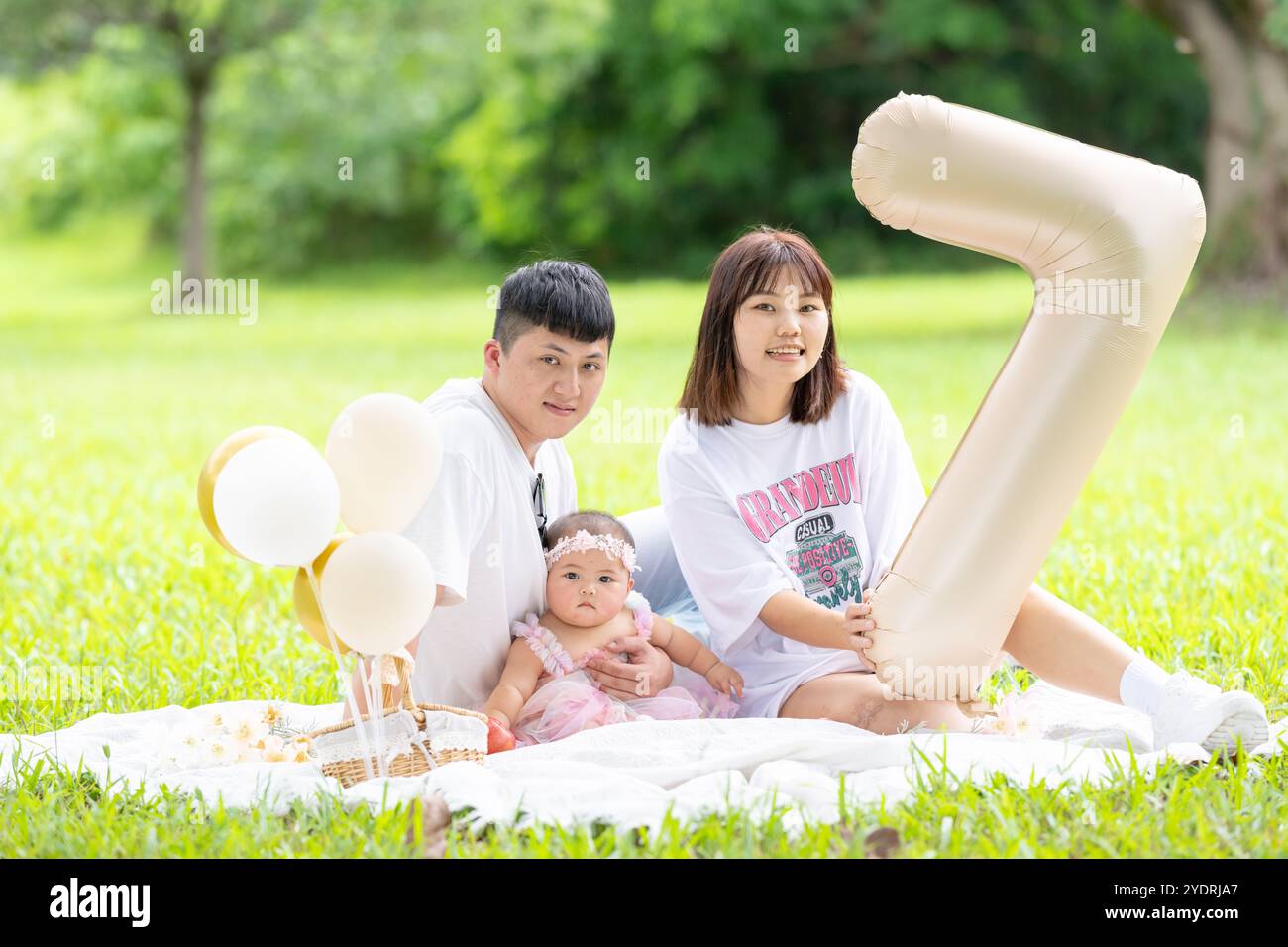 A Taiwanese couple in their 20s and their 7-month-old baby celebrate a ...