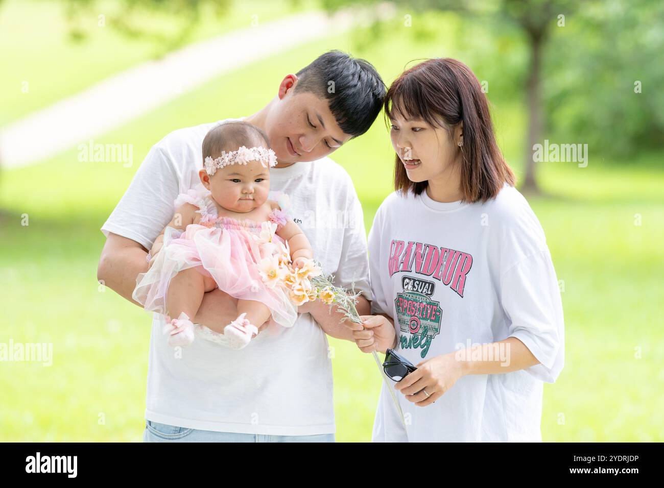A Taiwanese couple in their 20s and their 7-month-old baby celebrate a ...