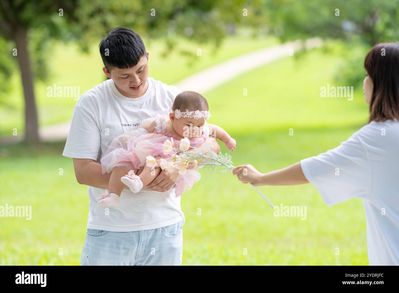 A Taiwanese couple in their 20s and their 7-month-old baby celebrate a ...