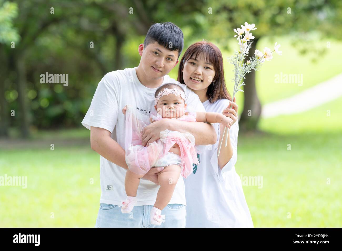 A Taiwanese couple in their 20s and their 7-month-old baby celebrate a ...