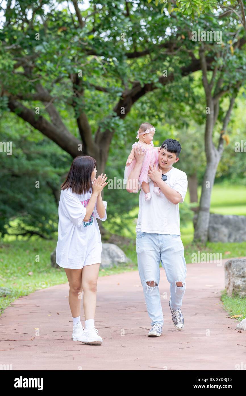 A Taiwanese couple in their 20s and their 7-month-old baby celebrate a ...