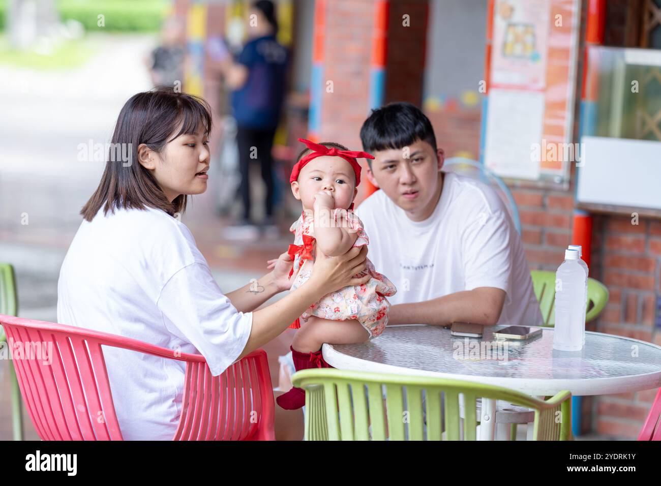 A Taiwanese couple in their 20s and their 7-month-old baby celebrate a ...