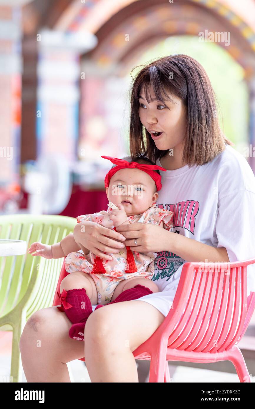 A Taiwanese couple in their 20s and their 7-month-old baby celebrate a ...