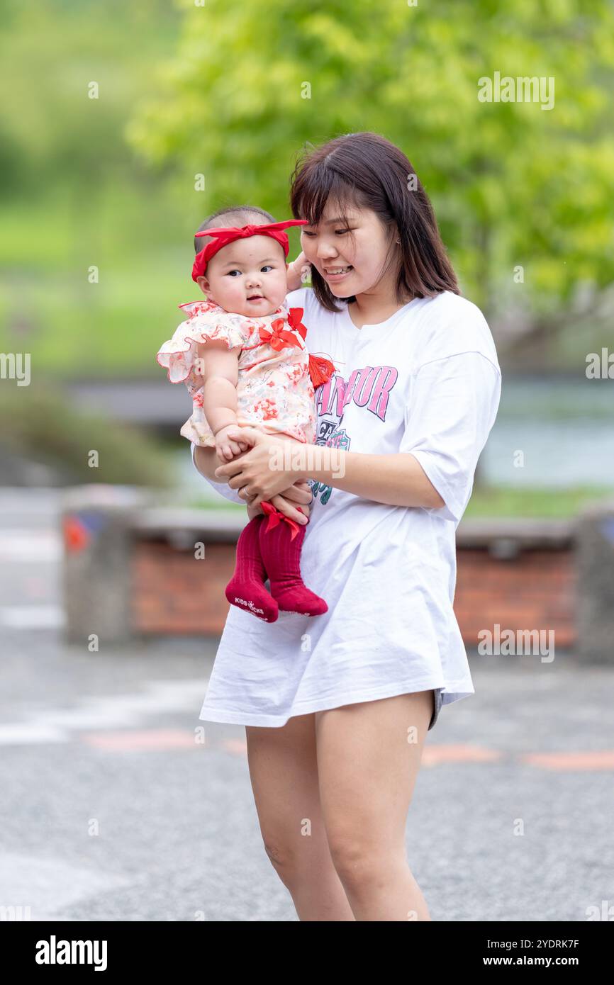 A Taiwanese couple in their 20s and their 7-month-old baby celebrate a ...