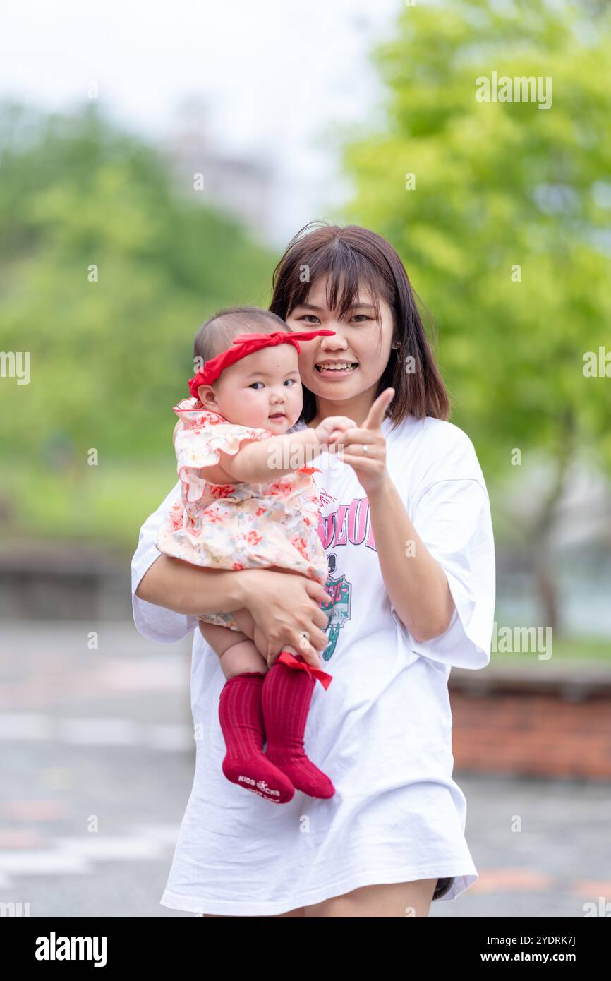 A Taiwanese couple in their 20s and their 7-month-old baby celebrate a ...