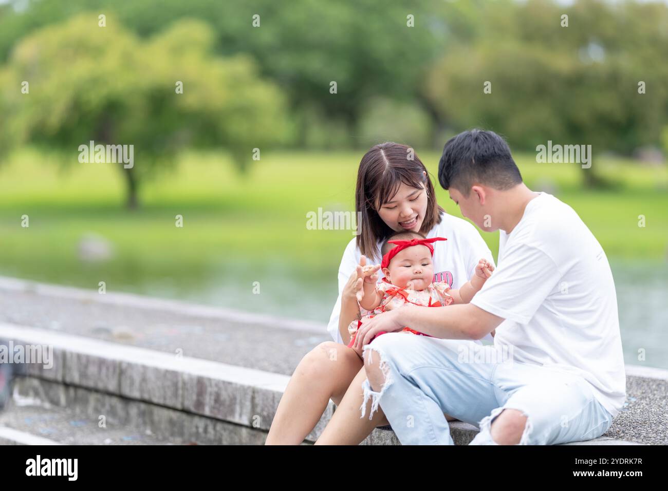 A Taiwanese couple in their 20s and their 7-month-old baby celebrate a ...