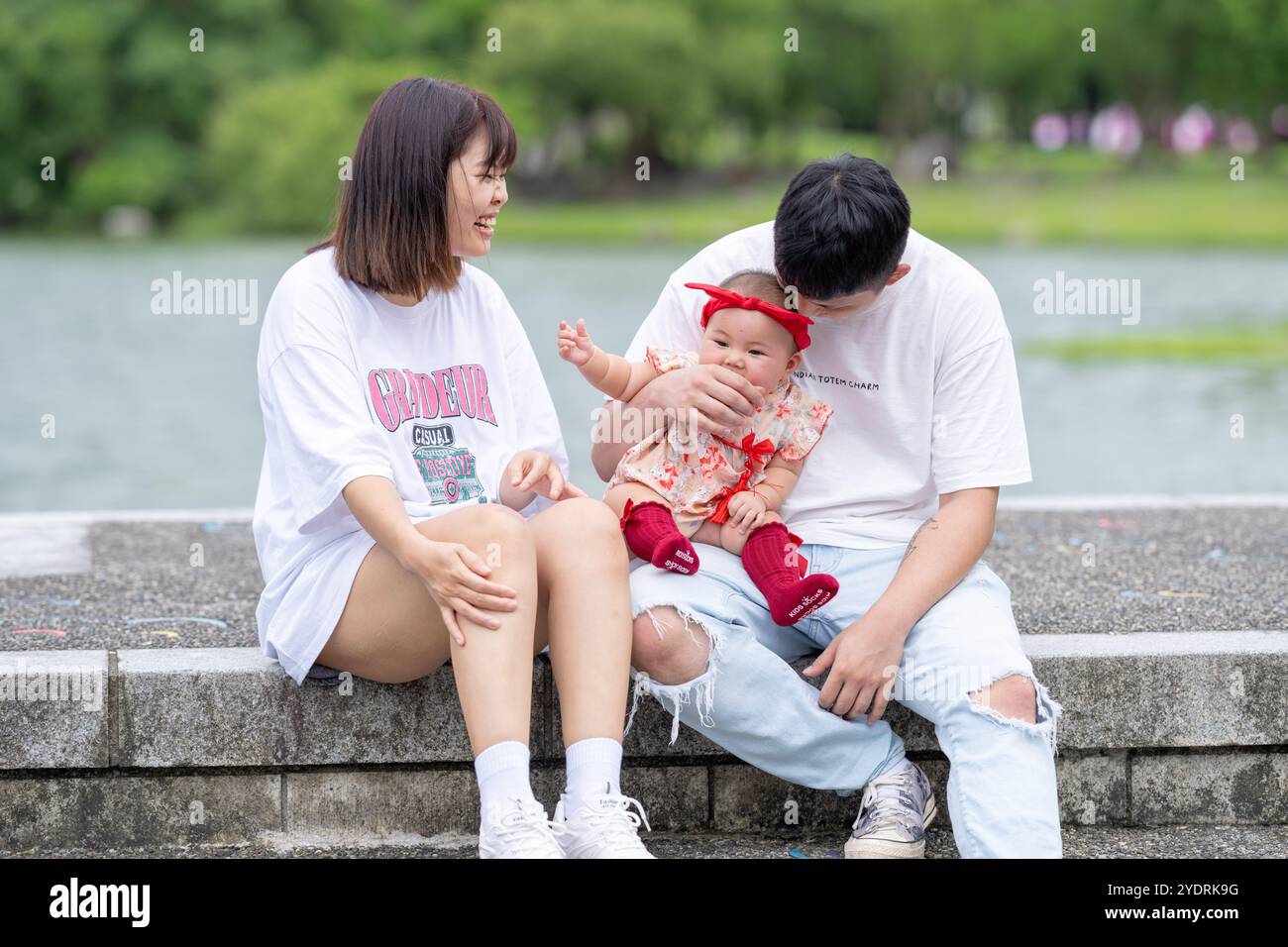 A Taiwanese couple in their 20s and their 7-month-old baby celebrate a ...